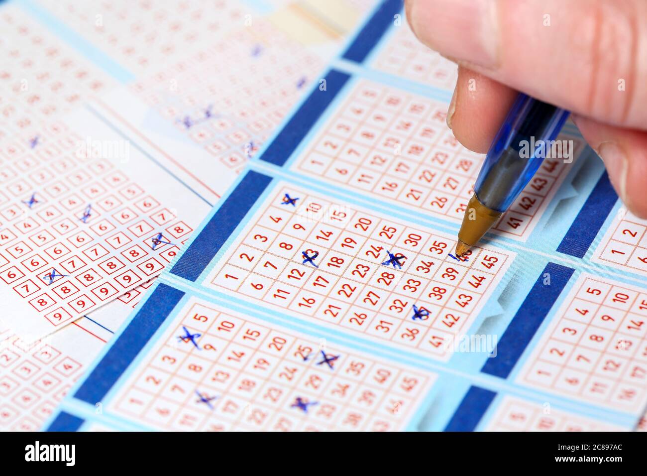 hand with pen picking numbers on lottery ticket Stock Photo - Alamy