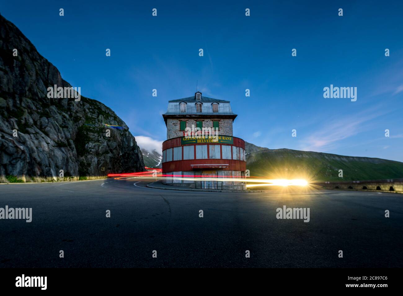longtexposure of passing car at a Hotel on a swiss alpine pass street ...
