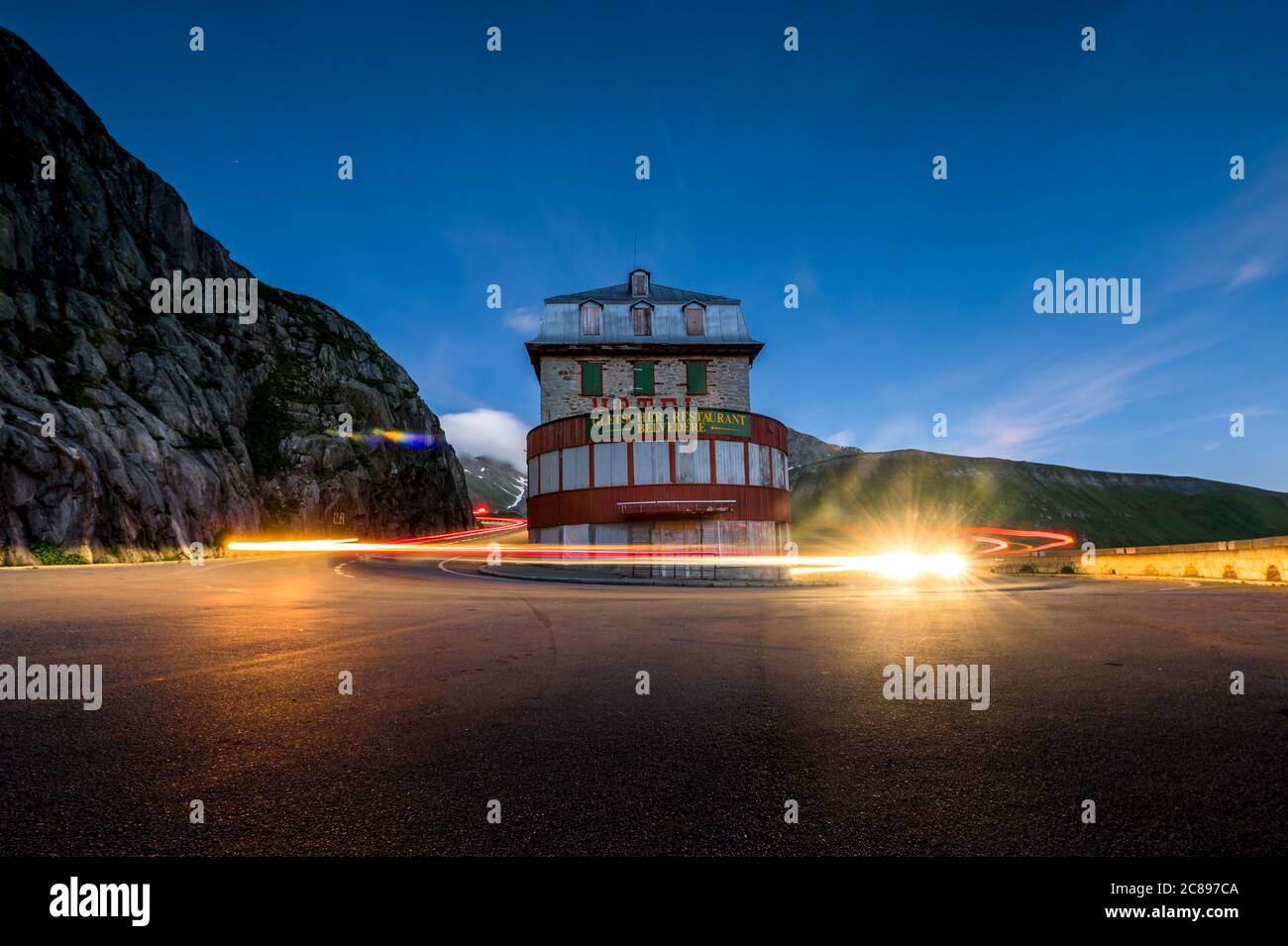 longtexposure of passing car at a Hotel on a swiss alpine pass street ...