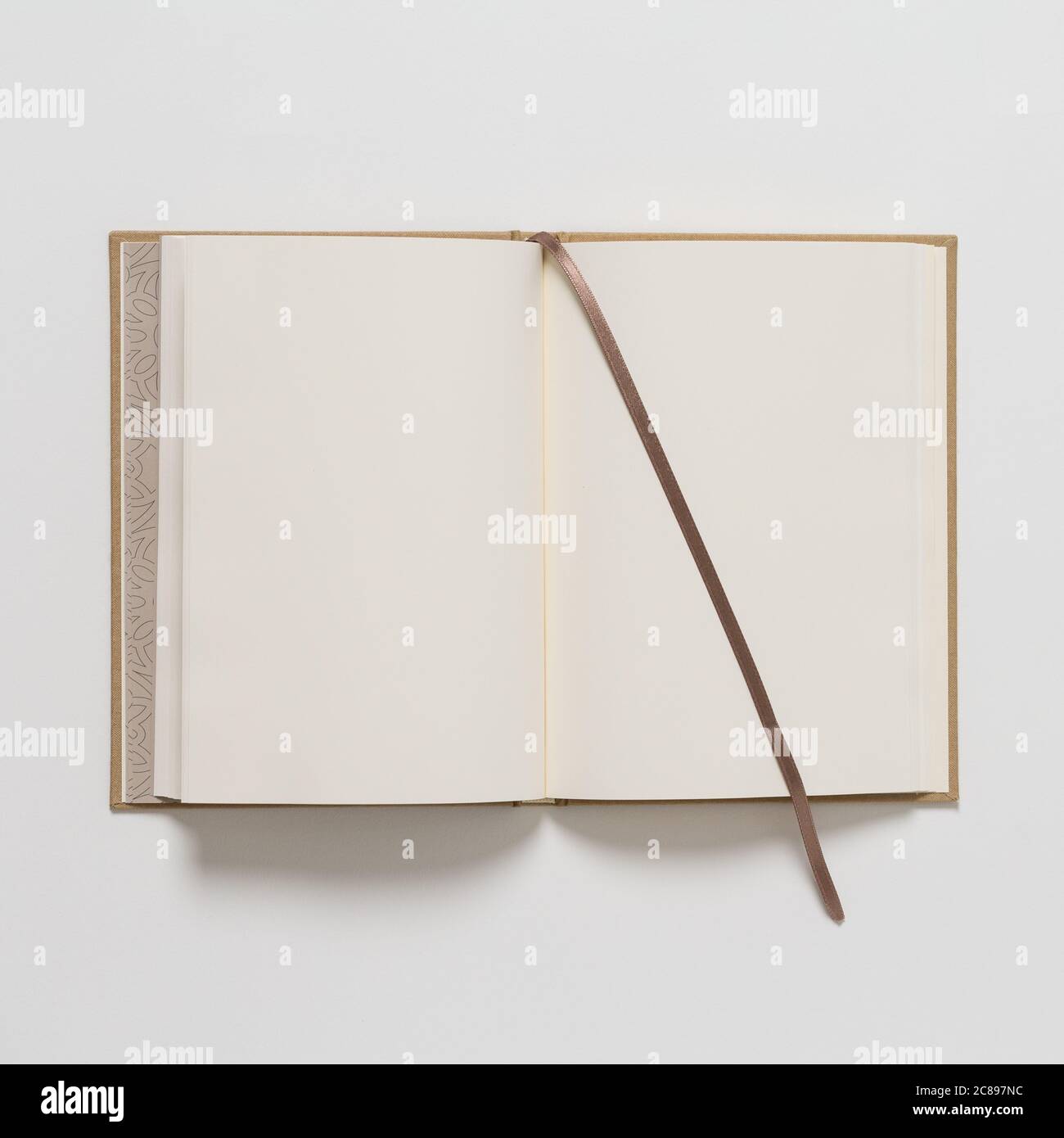 Overhead shot of an open notebook with blank pages on a white ...