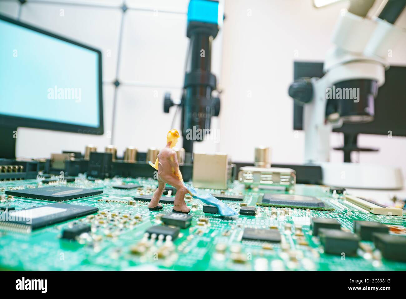 Miniature repair man on mainboard, Miniature figure of worker team try ...