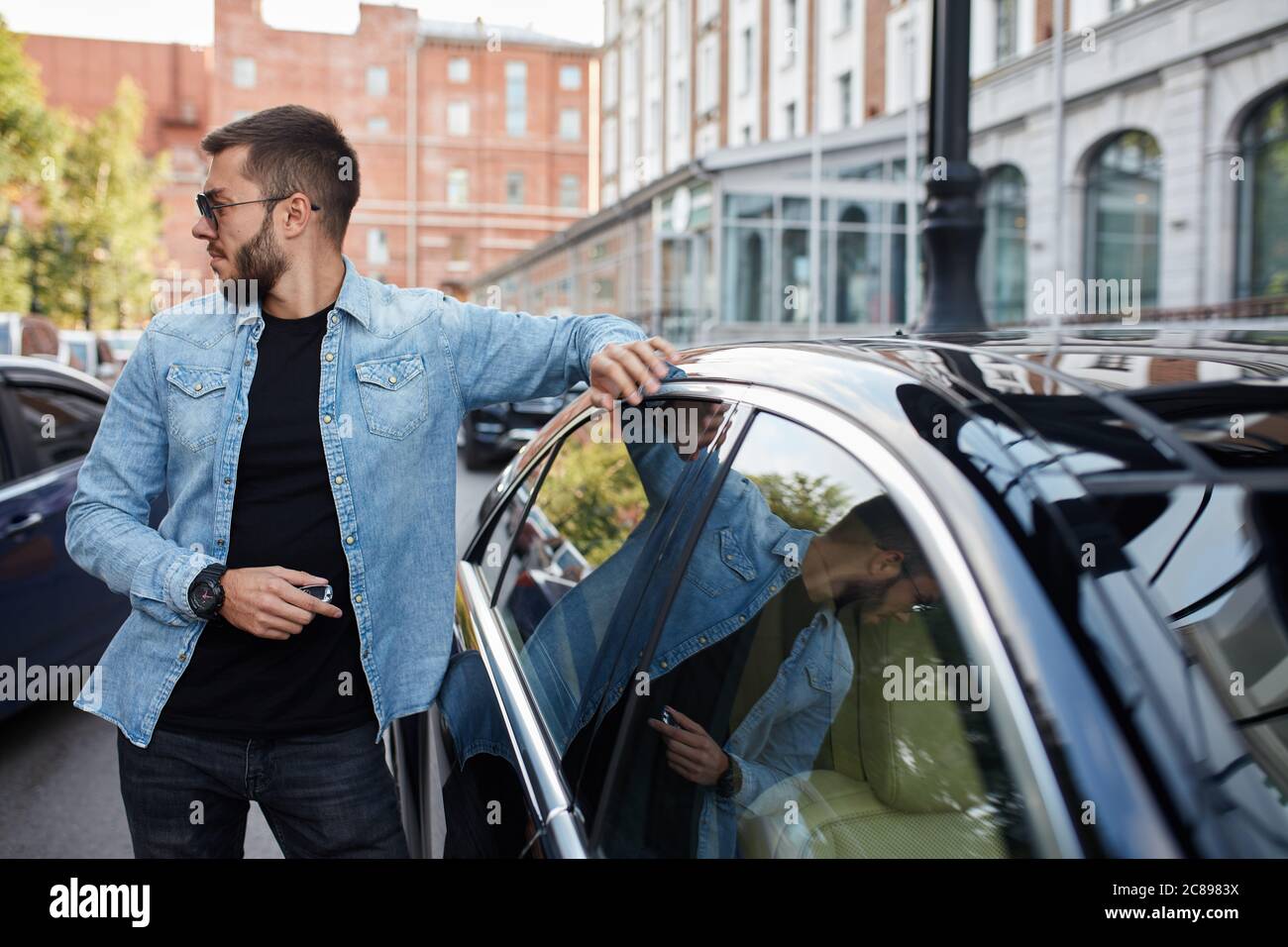 Handsome man leaning on his car. close up side view photo. presentation ...