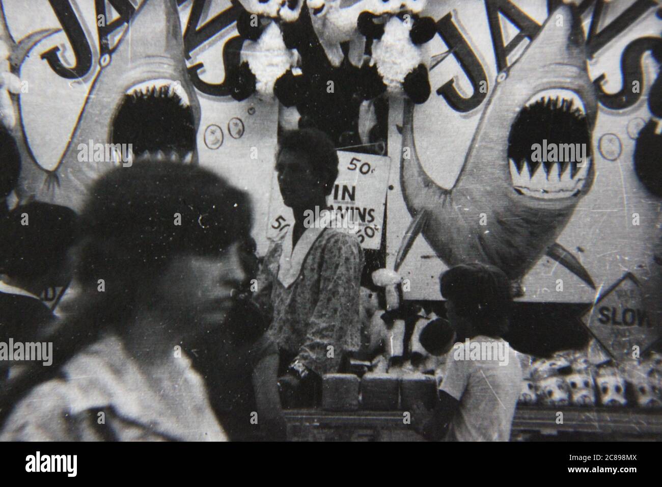 Fine 70s vintage black and white lifestyle photography of the popular carnival game of toss the ...