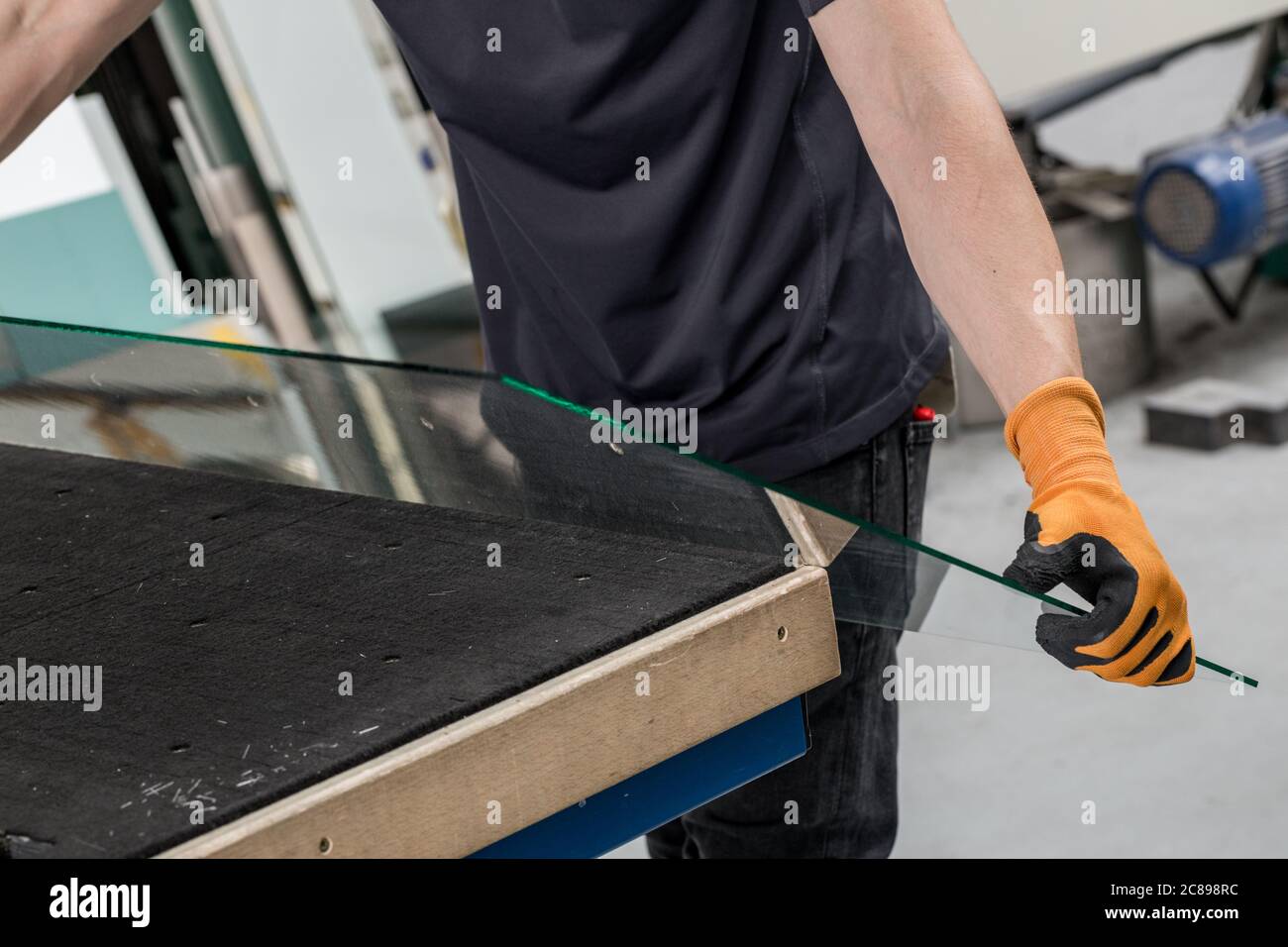 Glass factory, Glazier lifting that table glass Stock Photo - Alamy
