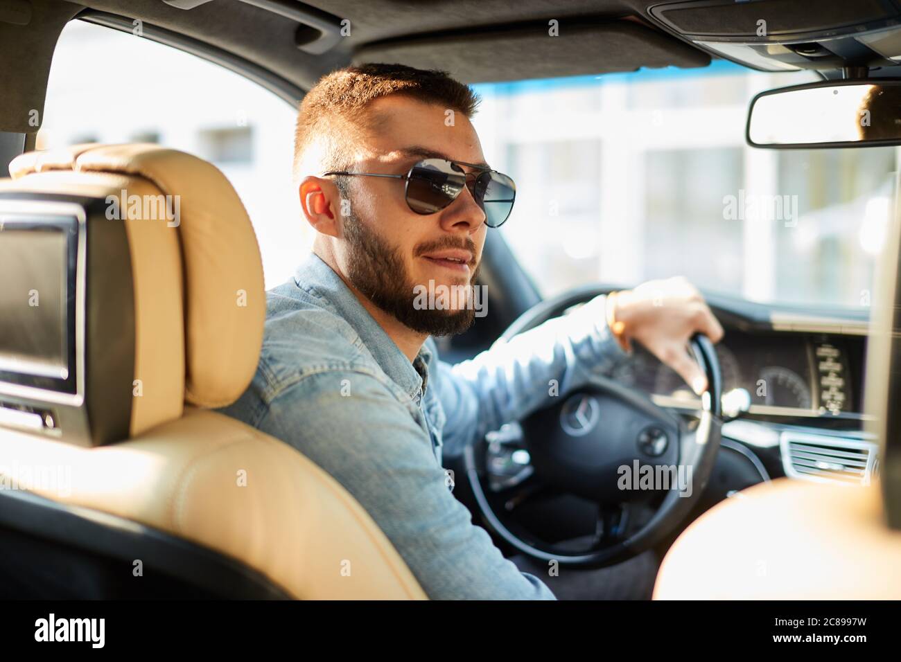 cool driver looking back while driving Mercedes-Benz. back view photo ...