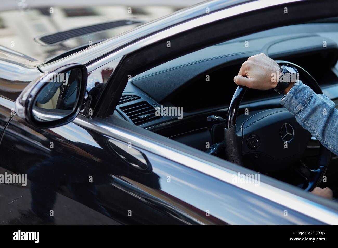 close up side view back view photo. man is sitting in the car and ...