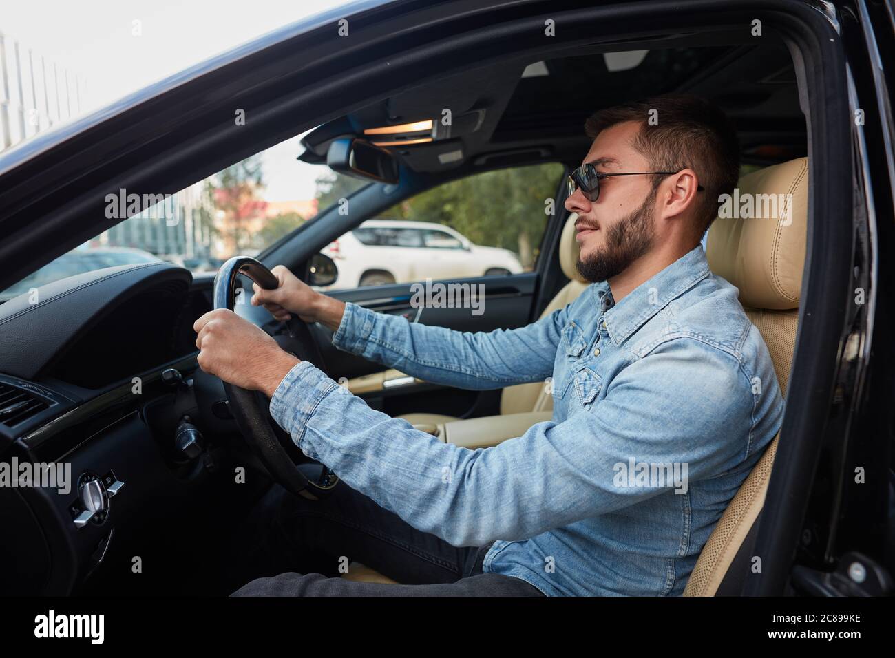 cool driver is in the fashion car. closeup side view photo. occupation ...