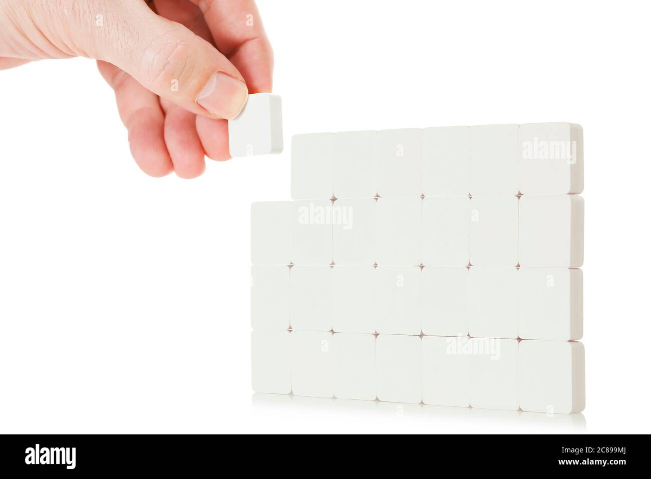 hand building a board with small blocks isolated on white Stock Photo ...
