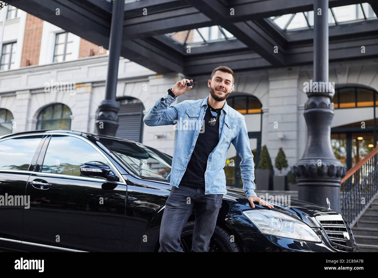 smart man has won a car in the lottery. happiness, prize, gift concept ...