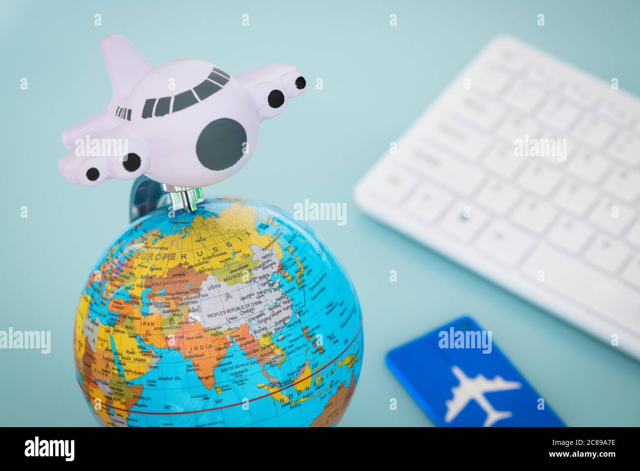 Desk with aviation and travel items. Globe, toy plane, Luggage tag ...
