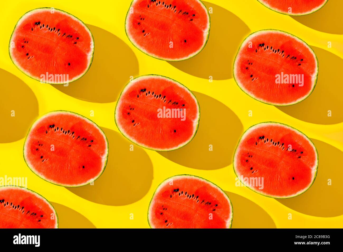 Large juicy, red watermelon on a yellow background. Summer backgrounds ...