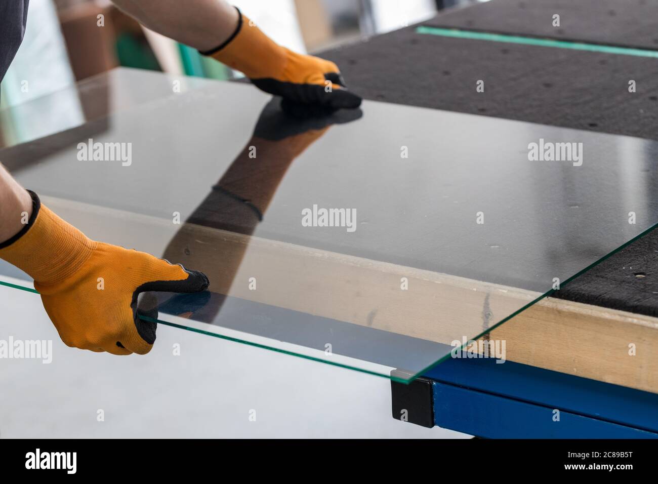 Glass factory, Glazier lifting that table glass Stock Photo - Alamy