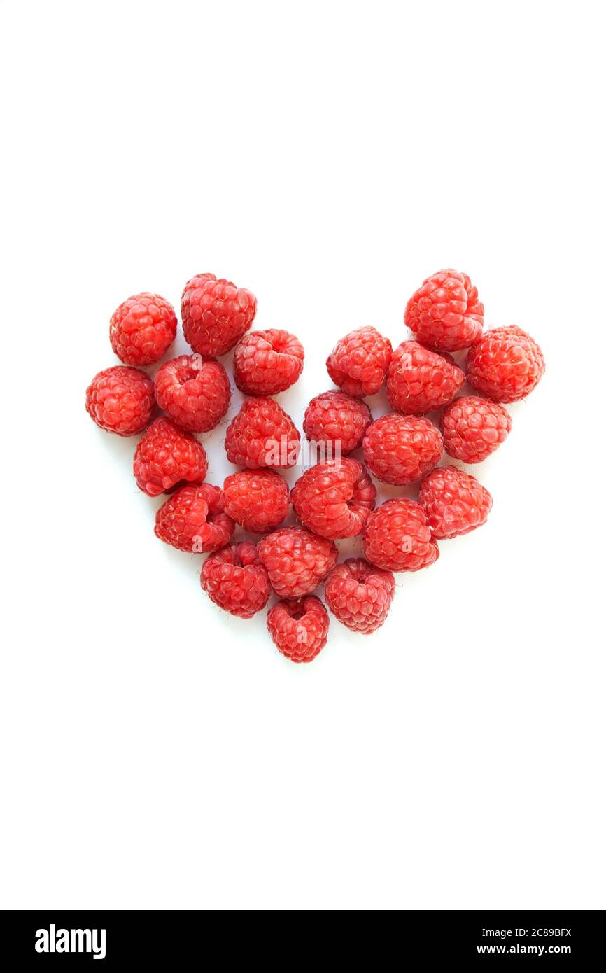 Ripe raspberries heart shaped composition isolated on white background ...