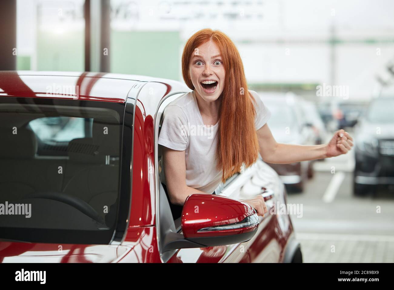 Overjoyed happy excited redheaded woman with real emotions receiving a ...