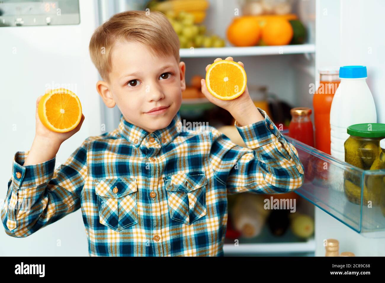 Boy standing in front of open fridge hi-res stock photography and ...