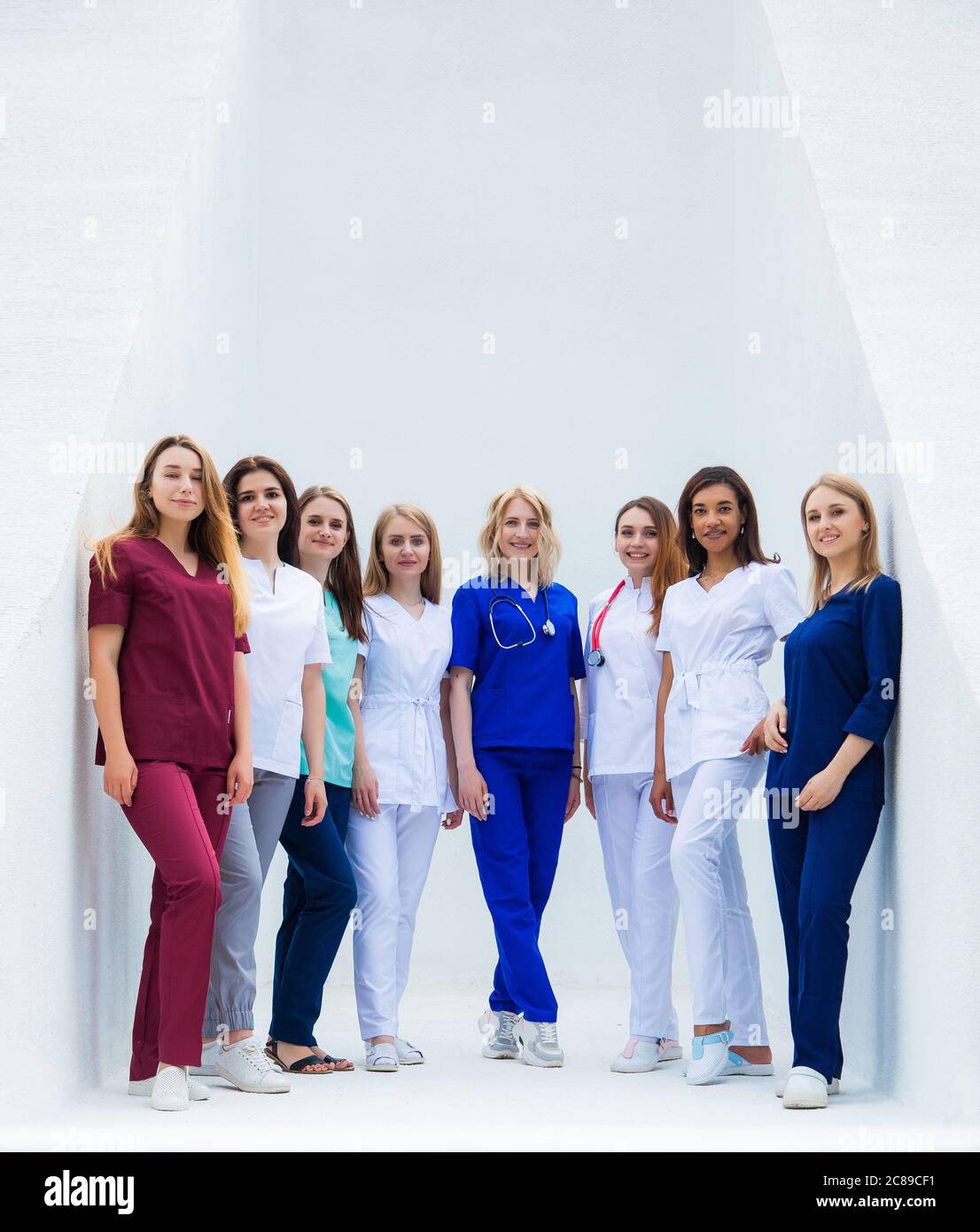 Medical students, university white wall background. A group of ...