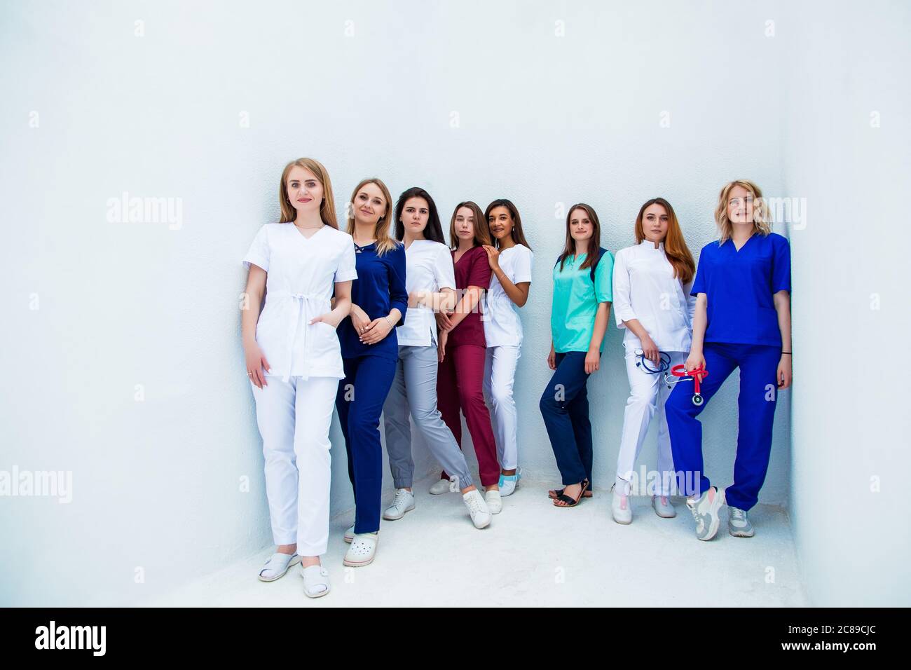 Medical students, university white wall background. A group of ...