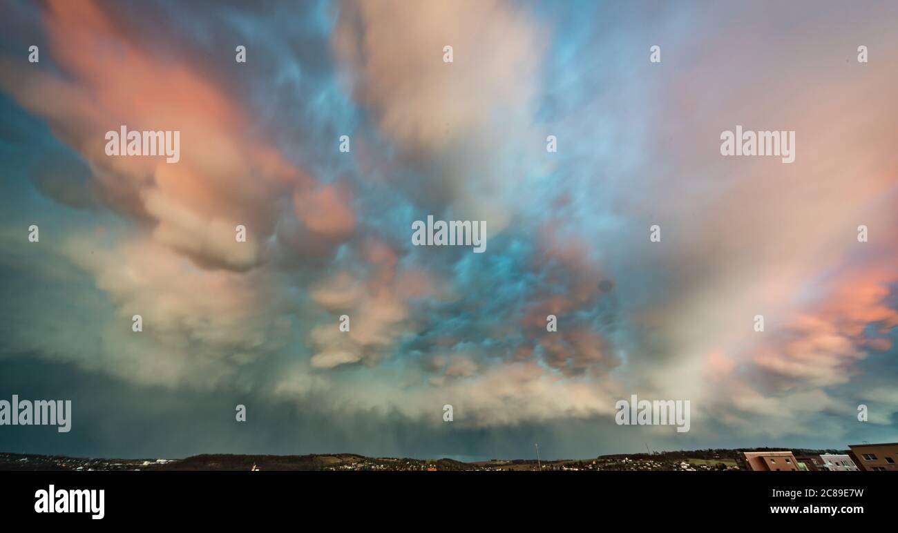 Illuminated storm clouds with rays of light hi-res stock photography ...