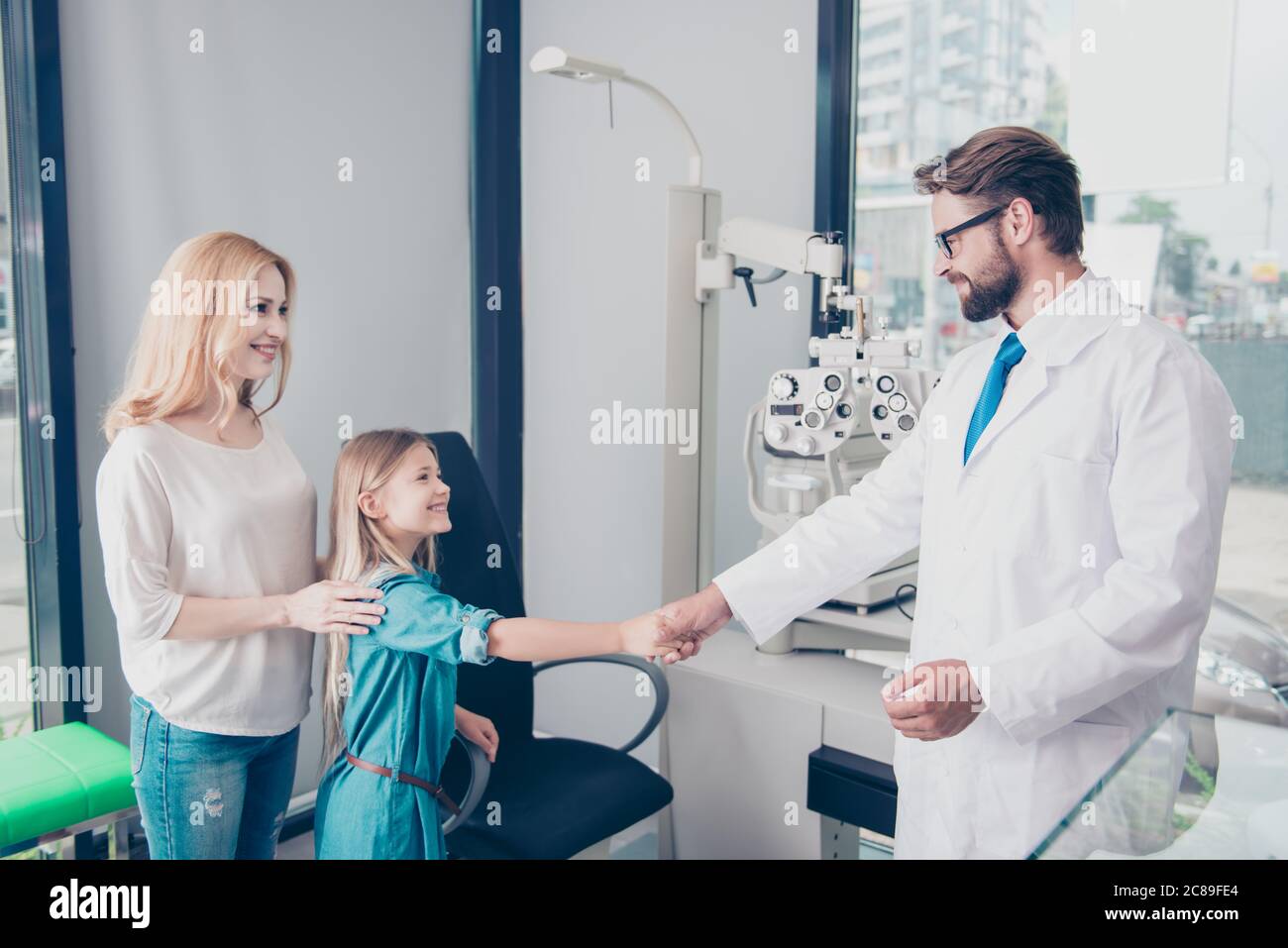 Small cute patient is saying thank you and bye to the friendly bearded ...