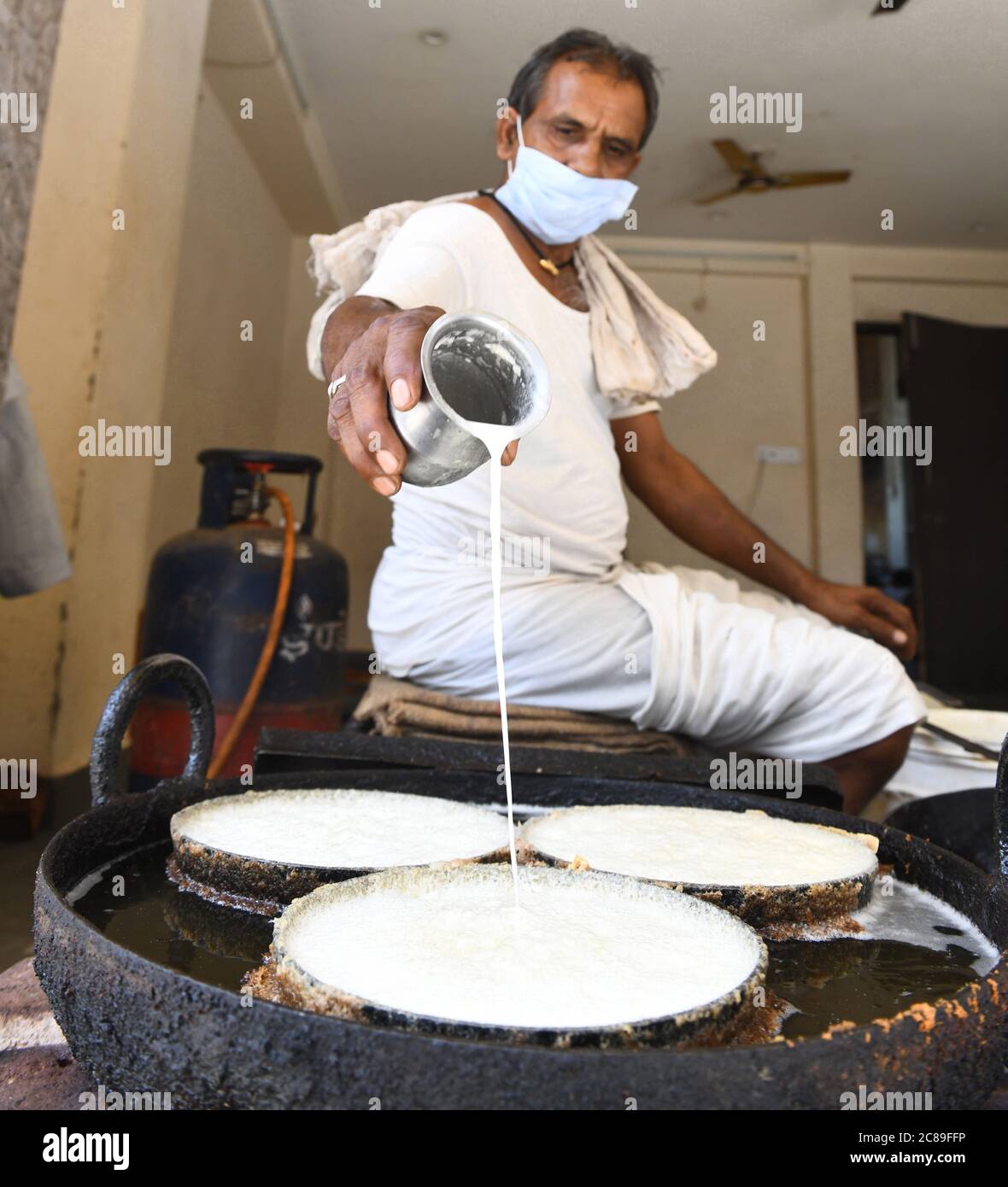 Beawar, Rajasthan, India, July 22, 2020: A confectioner makes 'Ghevar ...