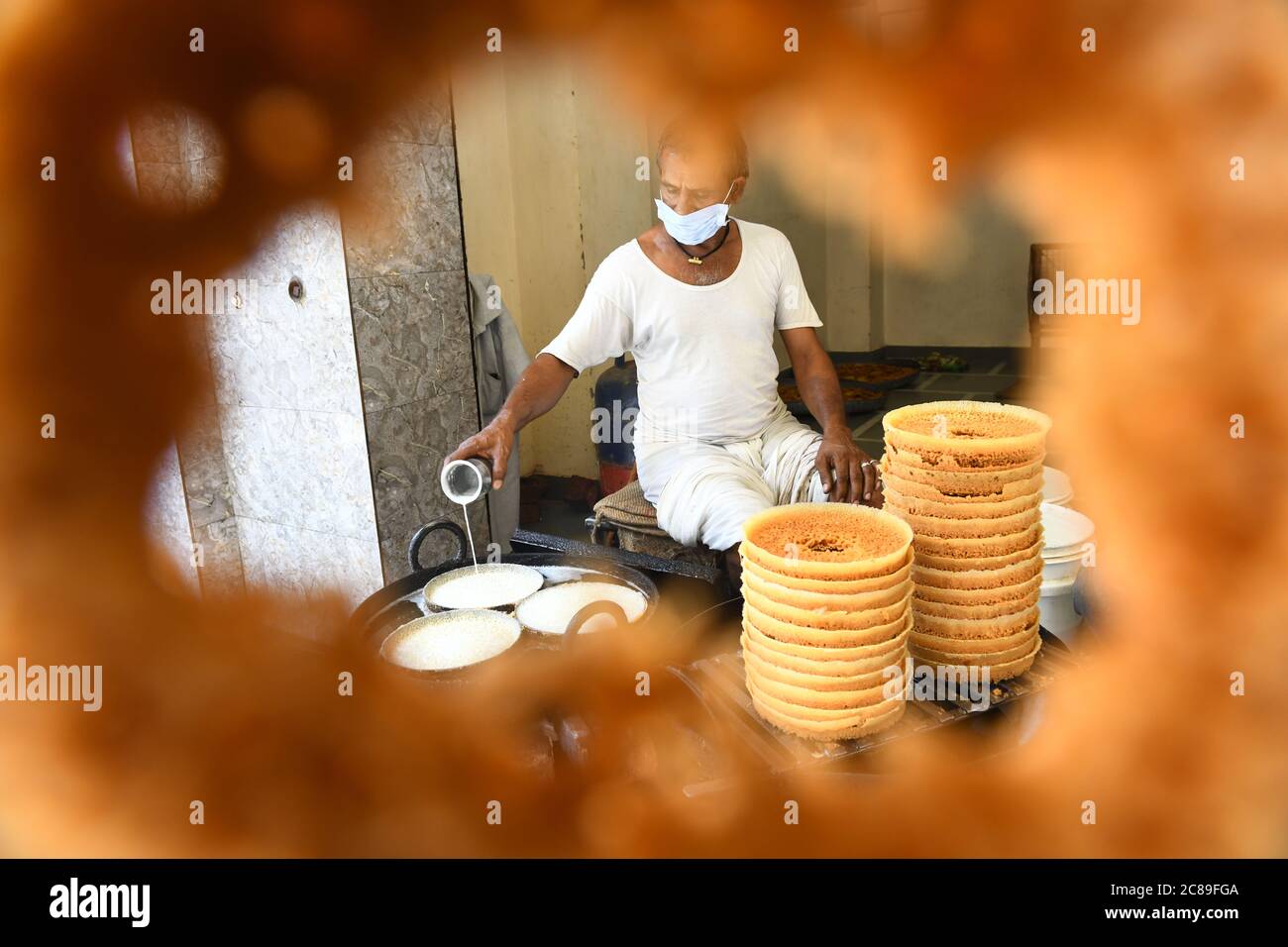 Beawar, Rajasthan, India, July 22, 2020: A confectioner makes 'Ghevar ...