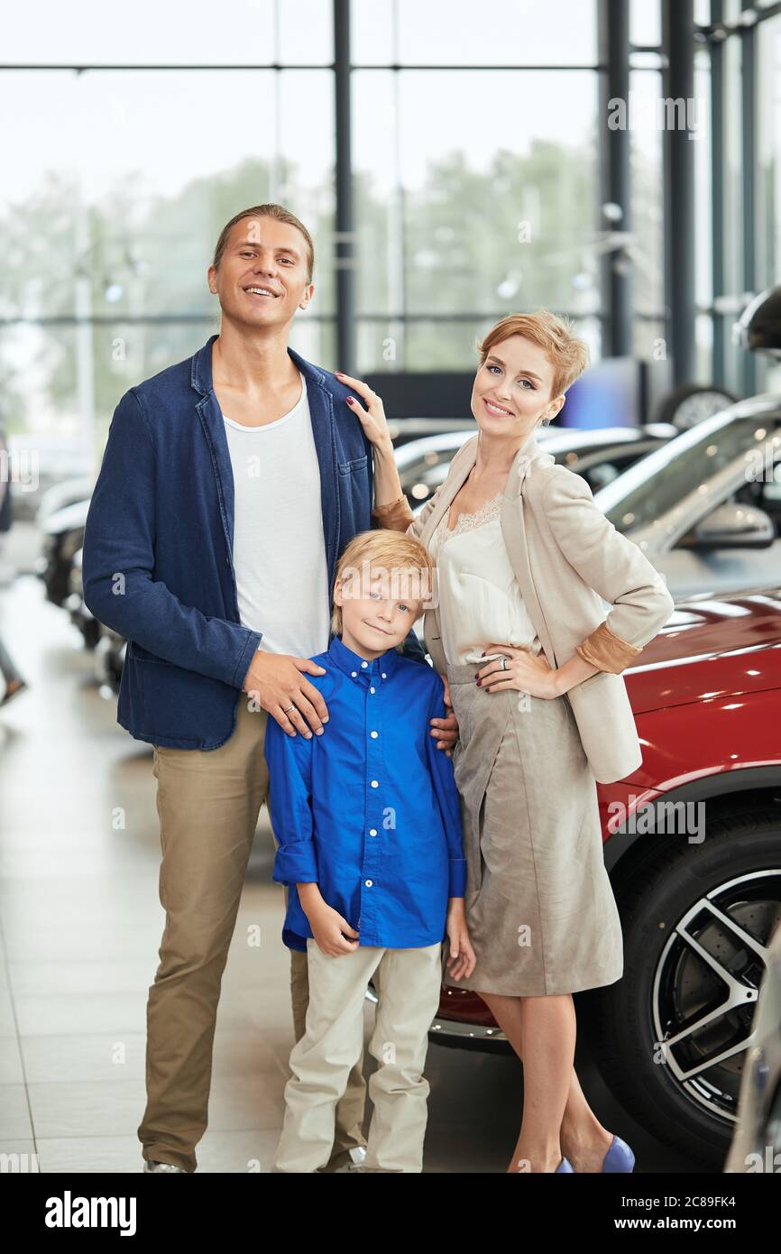 automobile sales centre. young family with child boy in car selling ...