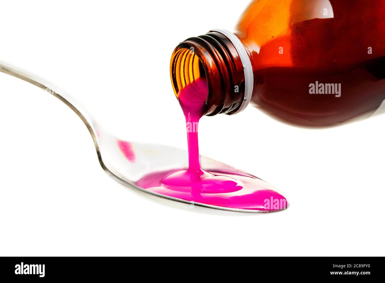 pouring cough or antipyretic syrup on spoon isolated on white Stock ...