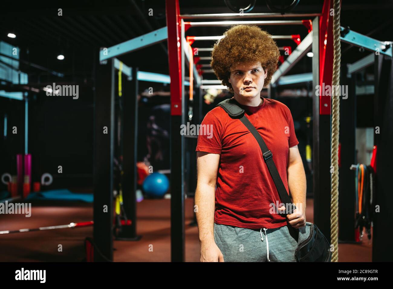 Overweight young man exercising in gym to achieve goals Stock Photo - Alamy