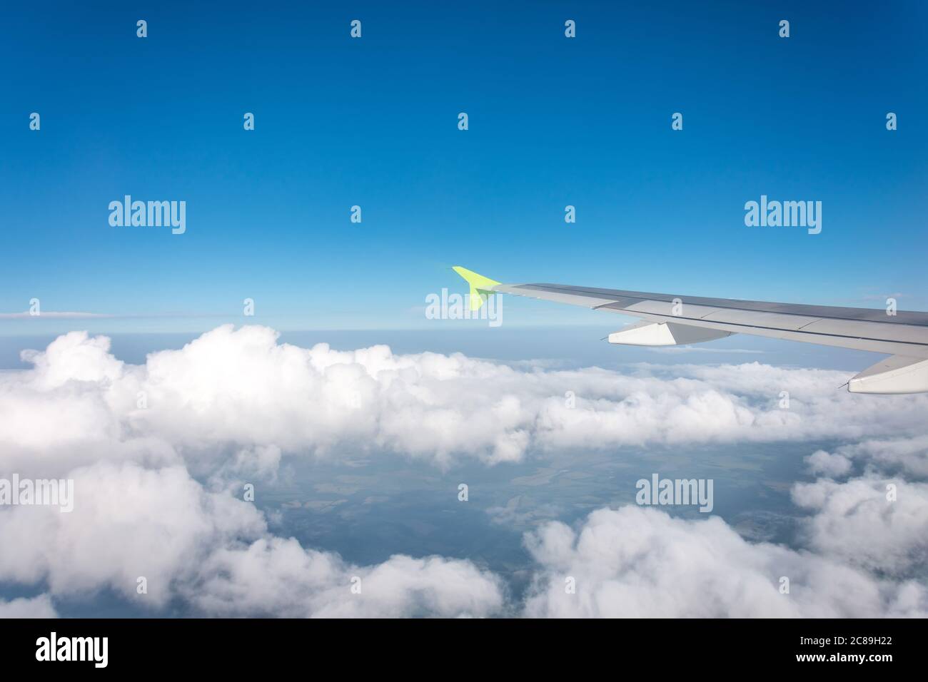 Wing view of the airplane on a winglets and jet engine, fluffy clouds ...
