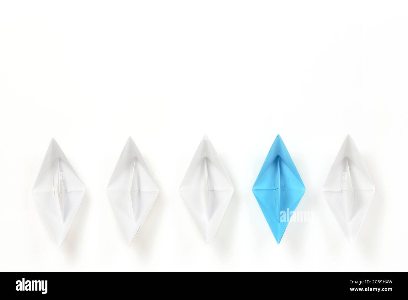 paper boats ready to race, one is different Stock Photo - Alamy