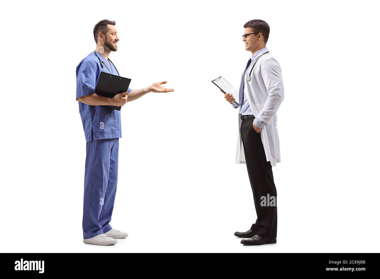 Full length profile shot of a doctor and a male nurse talking isolated ...