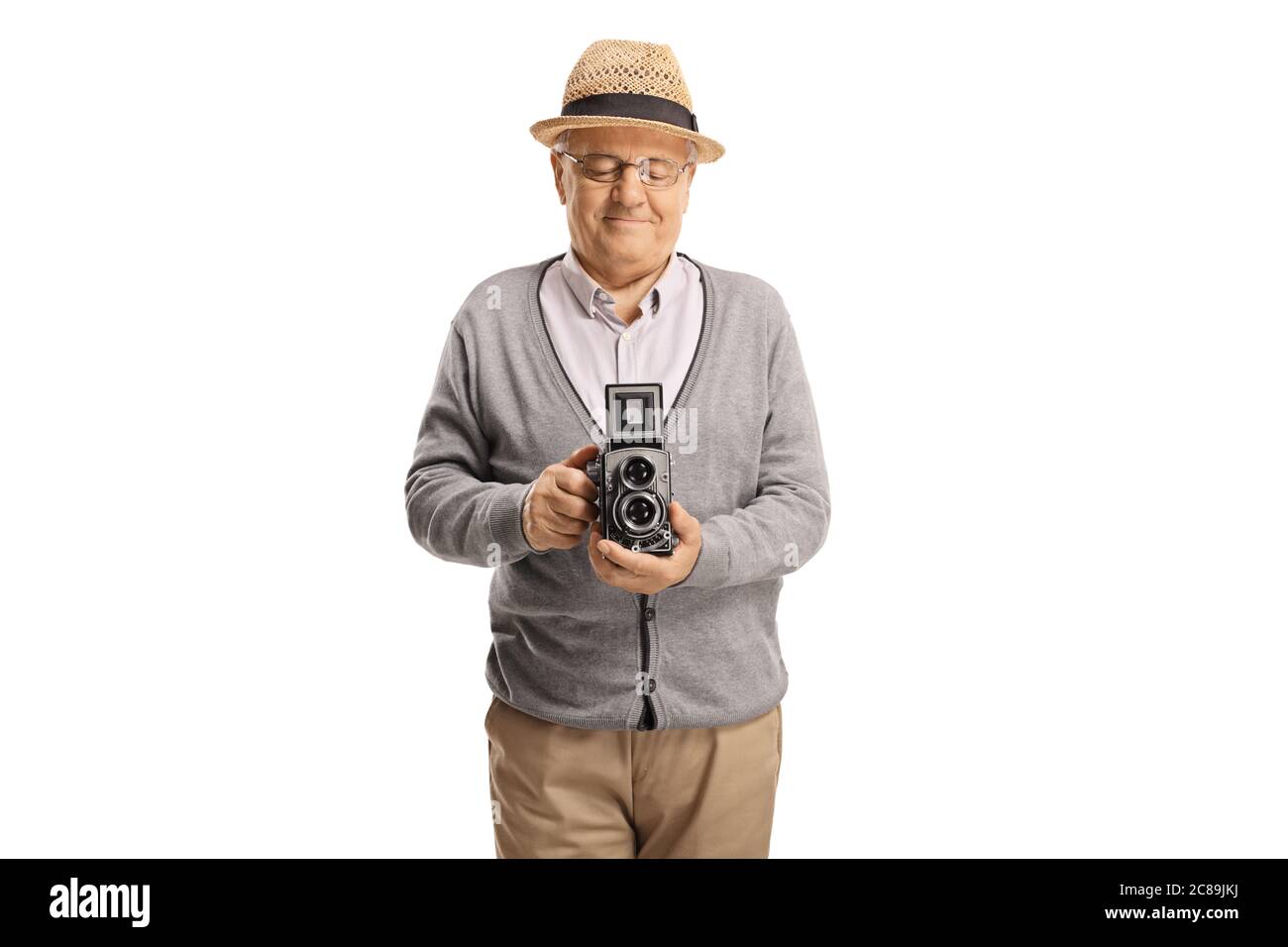 Elderly man recording with a vintage 8 mm camera recorder isolated on ...