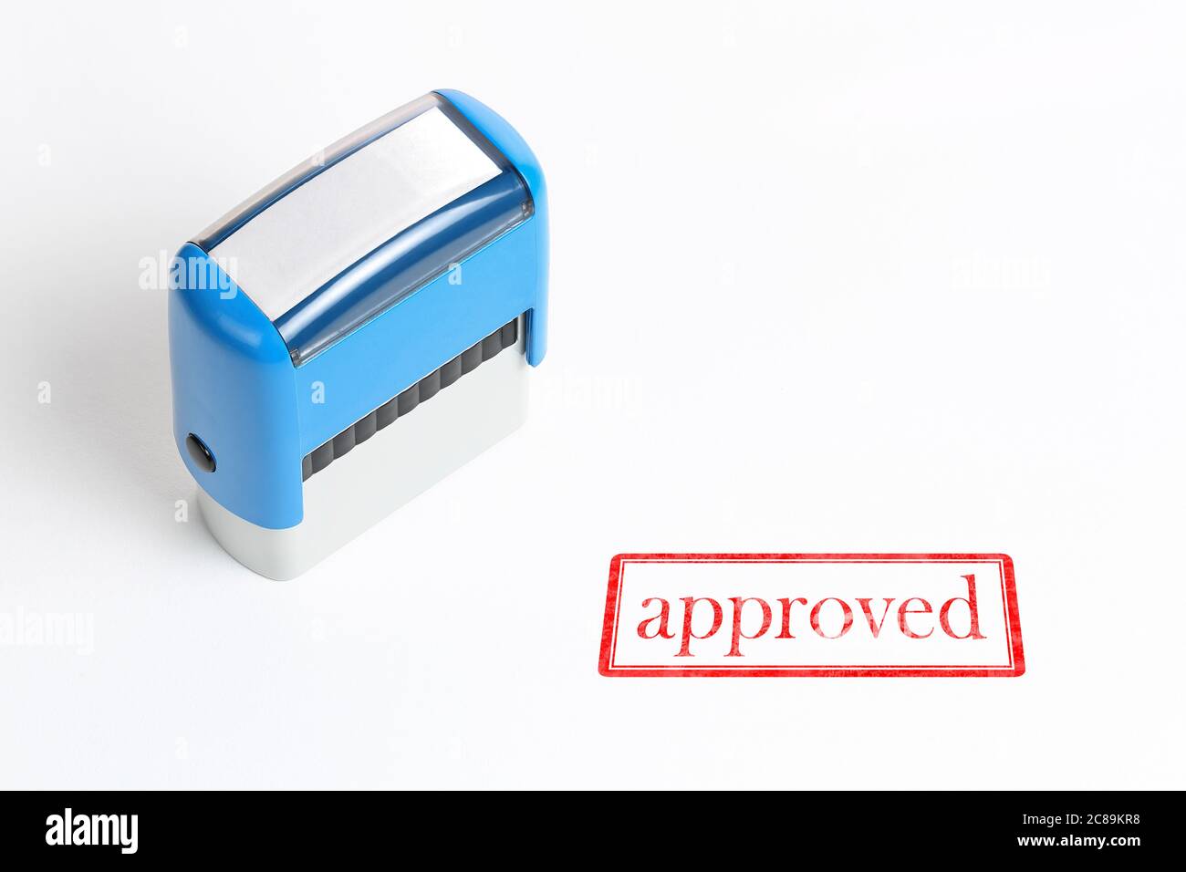 office stamp with approved stamp on white paper surface Stock Photo - Alamy