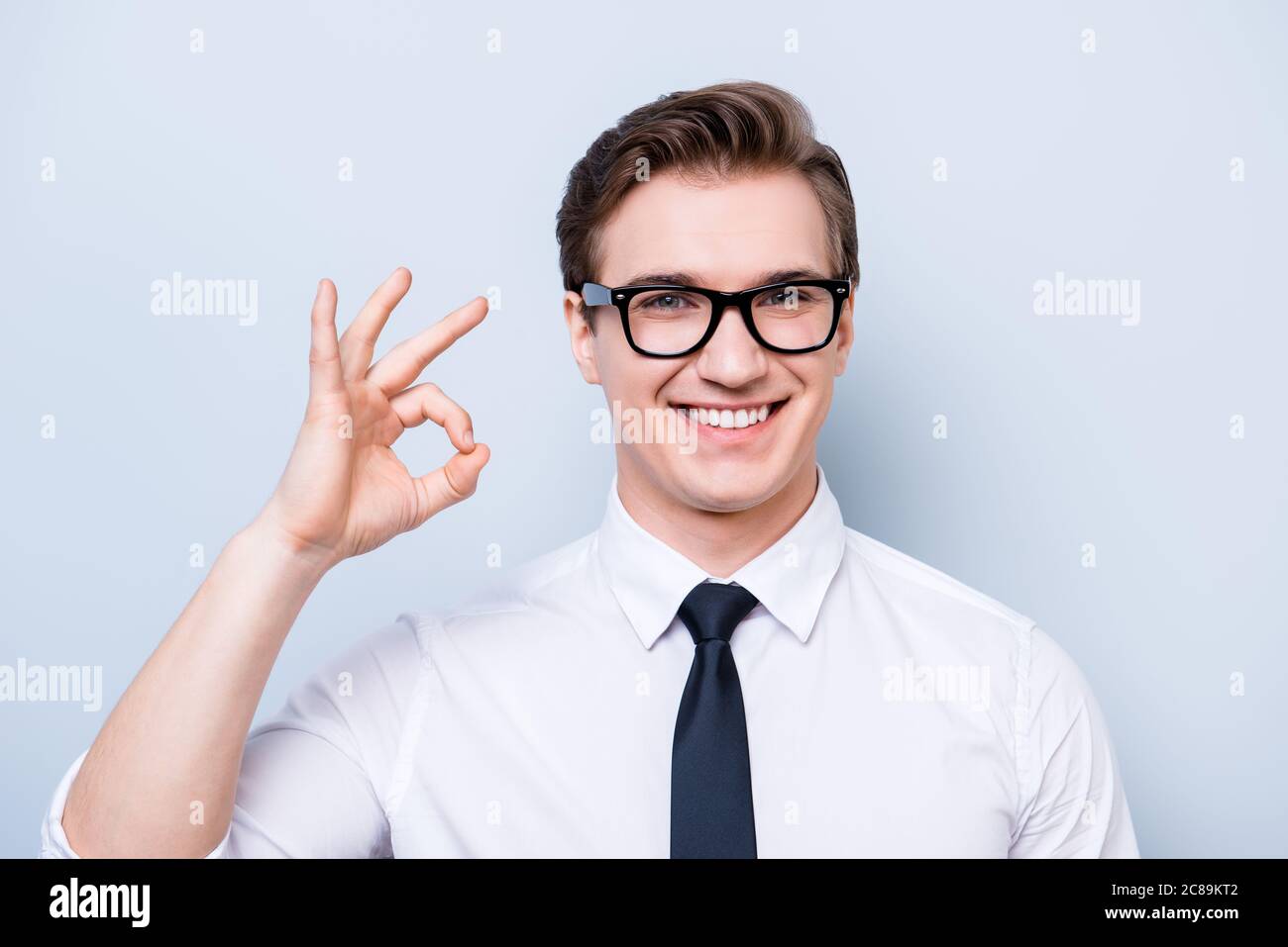 Success concept. Young handsome geek in a formal wear, black glasses ...