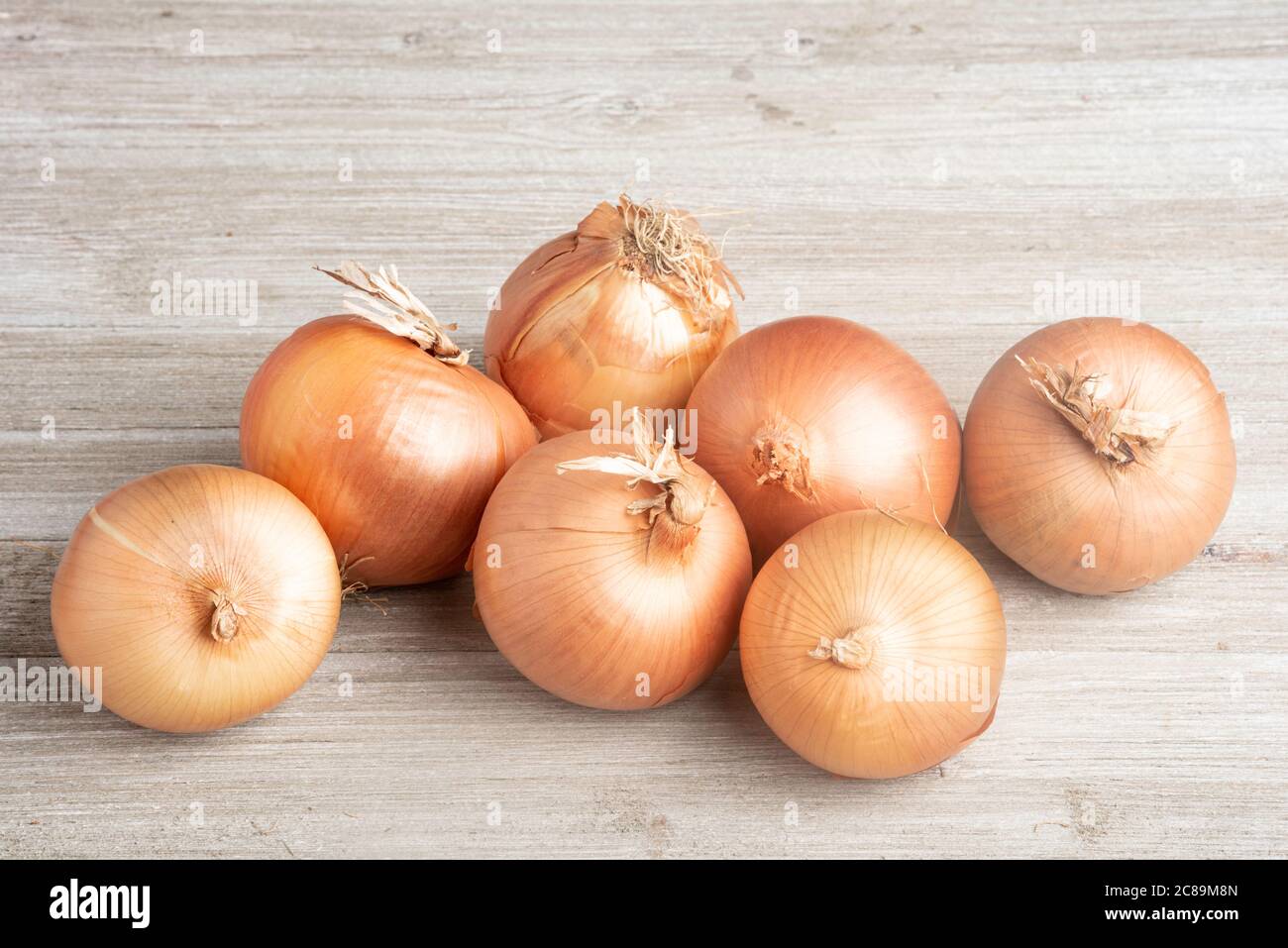 A bunch of fresh, authentic sweet southern-grown onions artfully ...