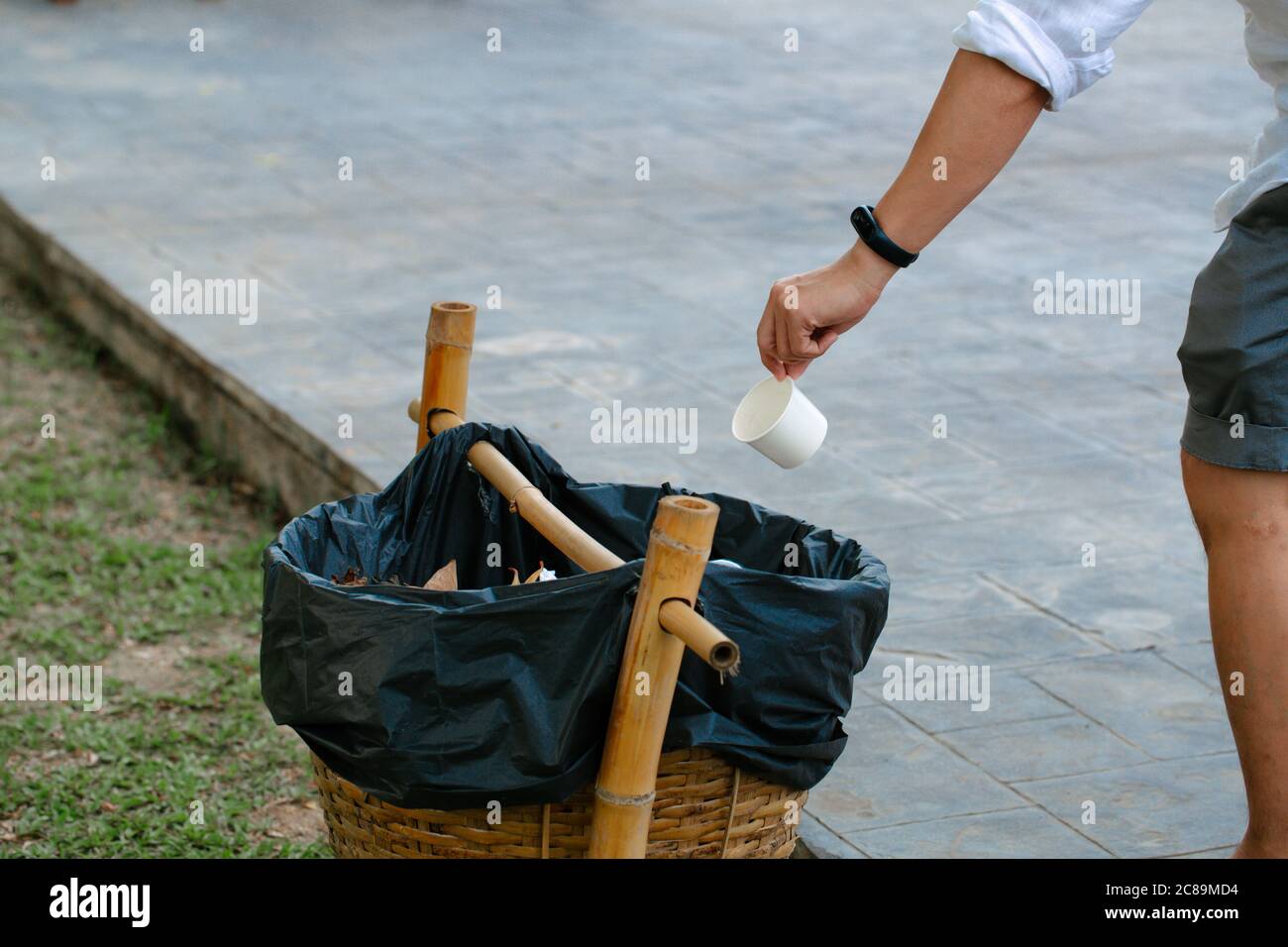 Man throwing rubbish in bin hi-res stock photography and images - Alamy