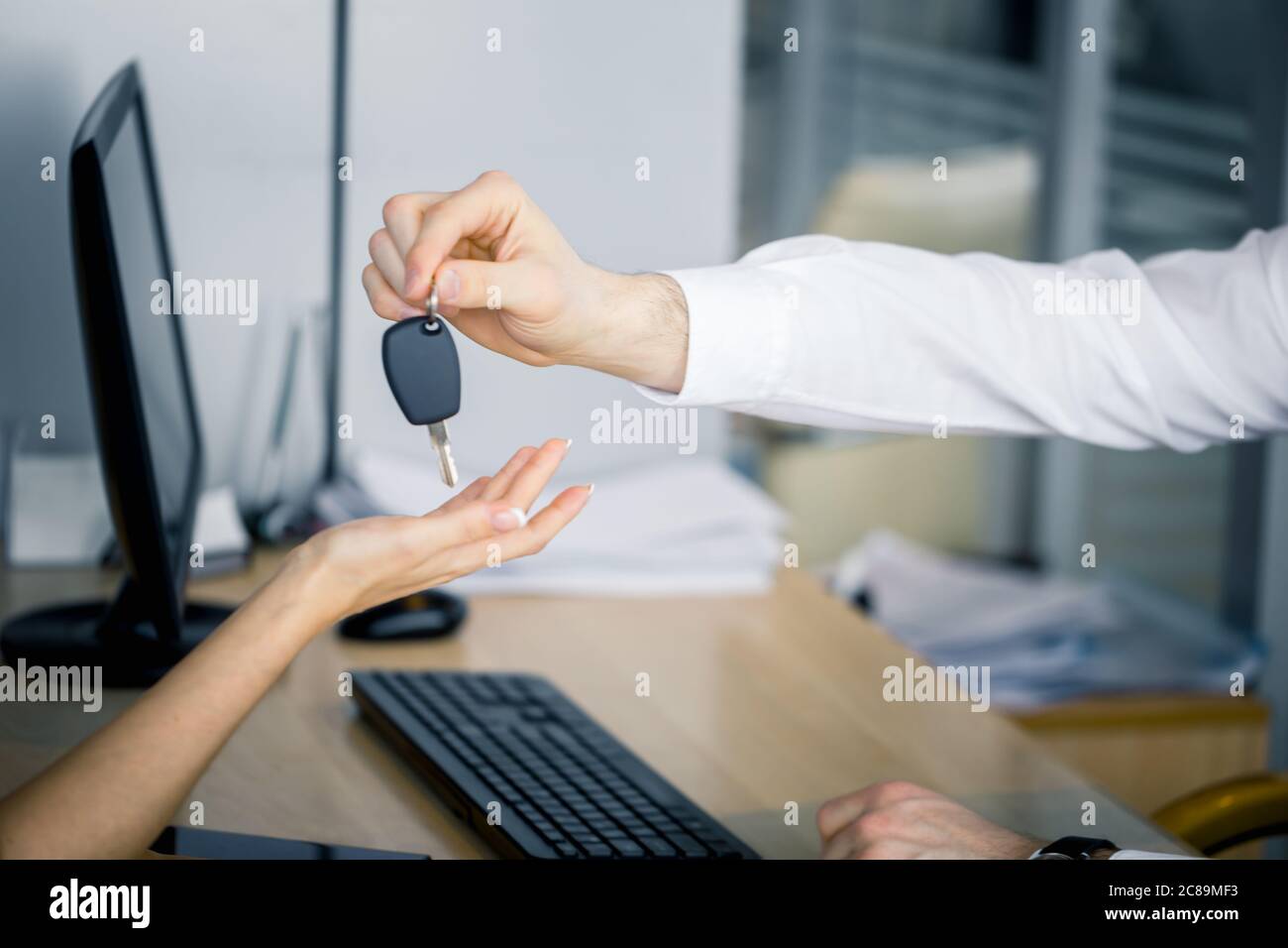 Woman handing over key hi-res stock photography and images - Alamy