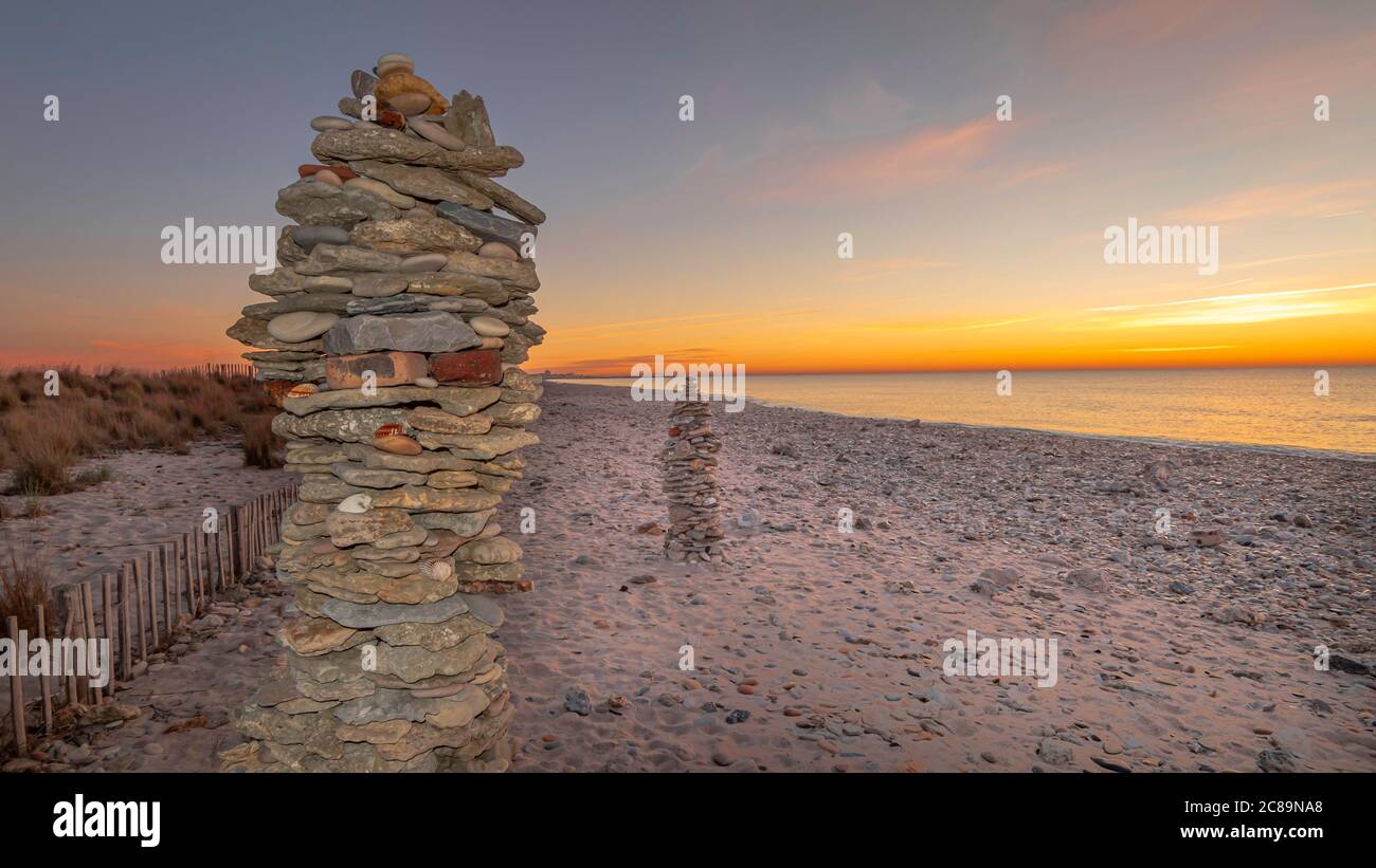 Pebble piling on a beach at sunset, zen atmosphere Stock Photo - Alamy