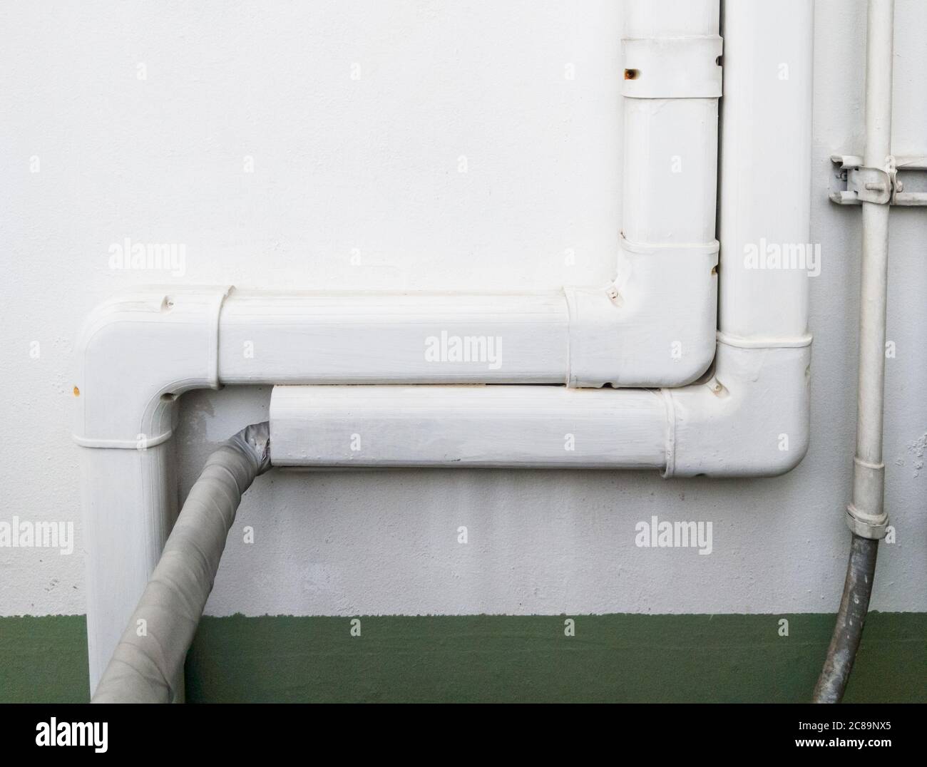 White plastic piping cover on the electric wire of the air conditioner ...