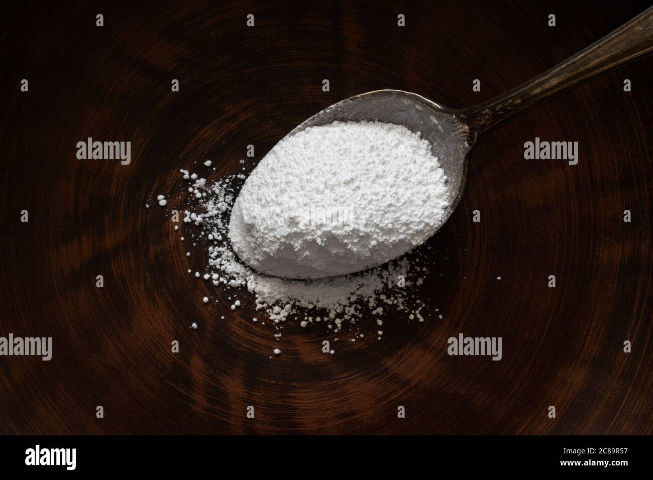 close-up of magnesium citrate in an iron spoon. dietary concept ...