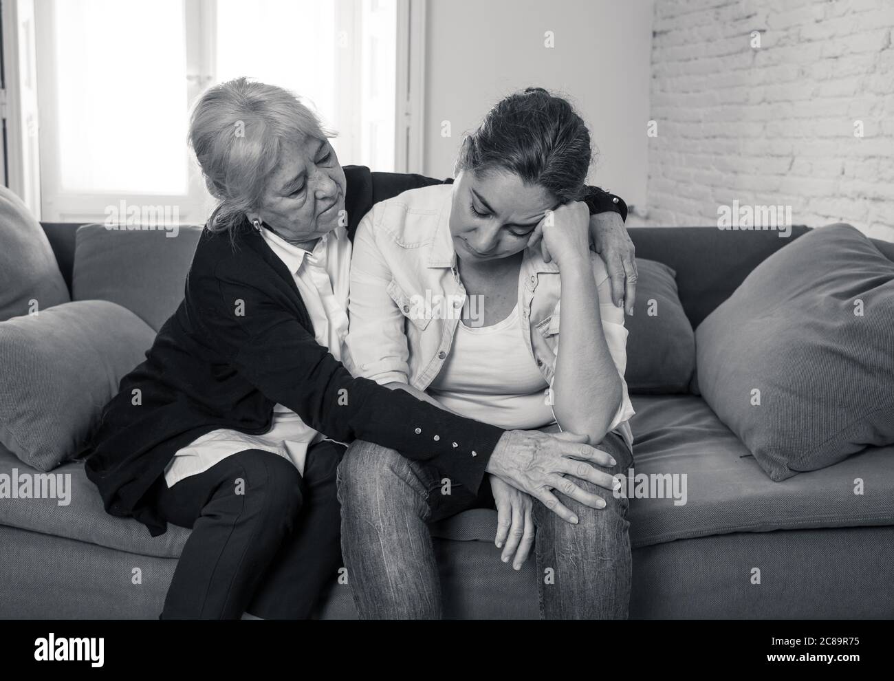 Senior mother comforting adult daughter grieving loss of loved one ...