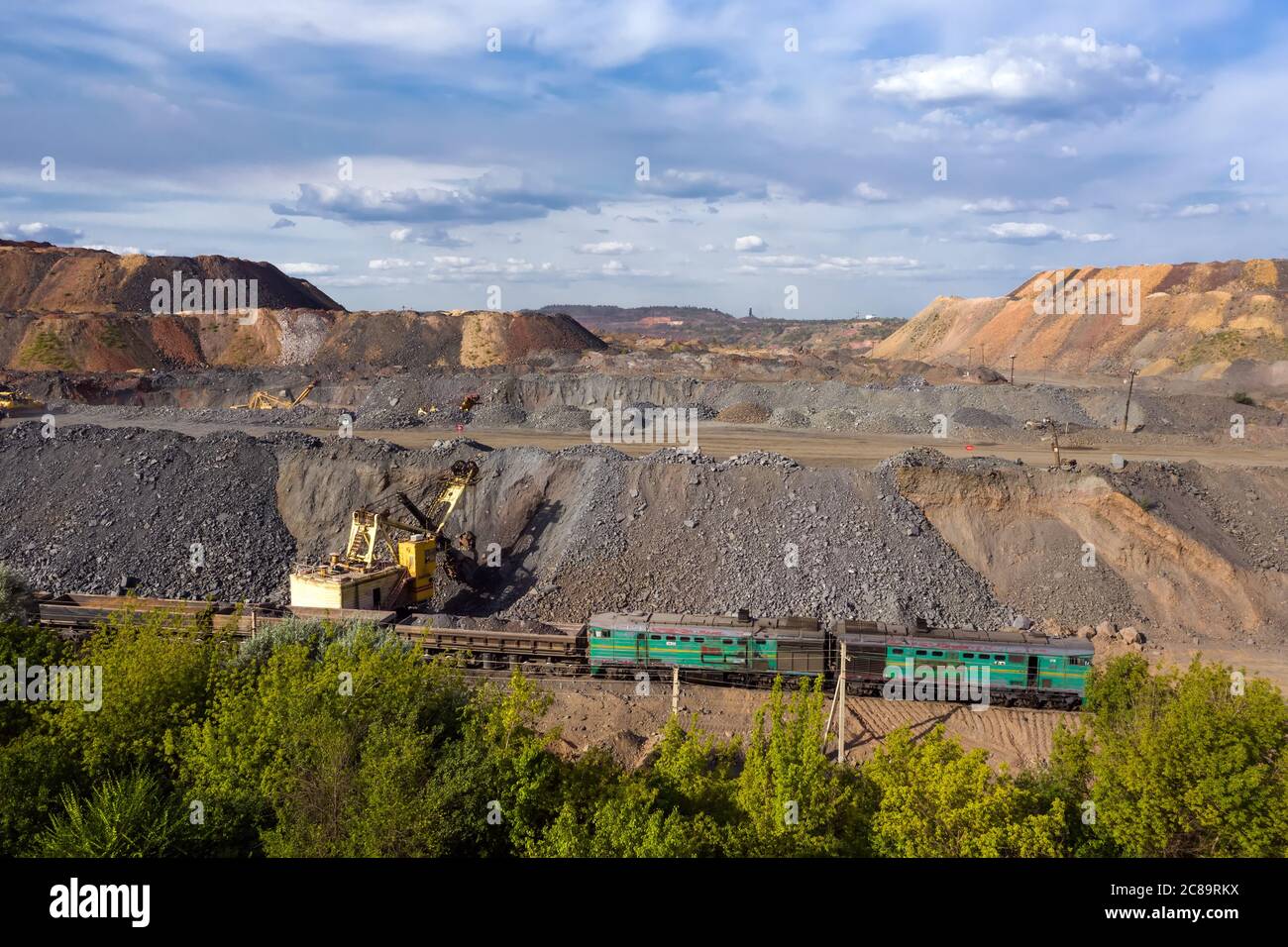 Cargo train carrying iron ore on the opencast mining quarry Stock Photo ...