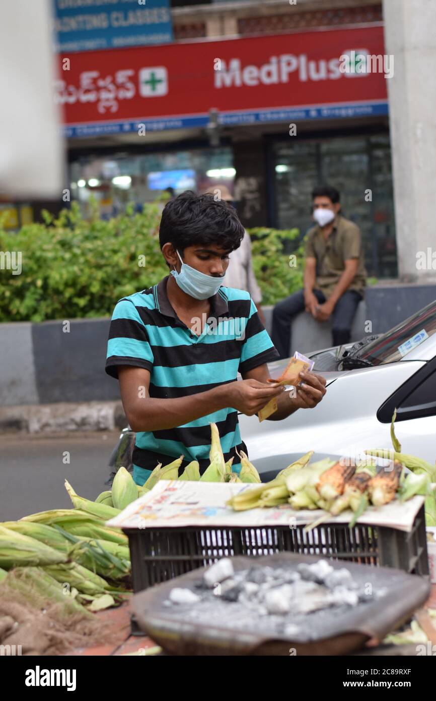 Hyderabad, Telangana, India. july-20-2020: Roasted corn, people are ...