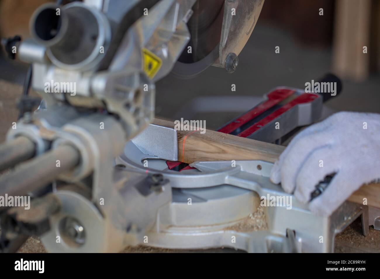 Marking wooden beam with red laser line for cutting with circular saw ...