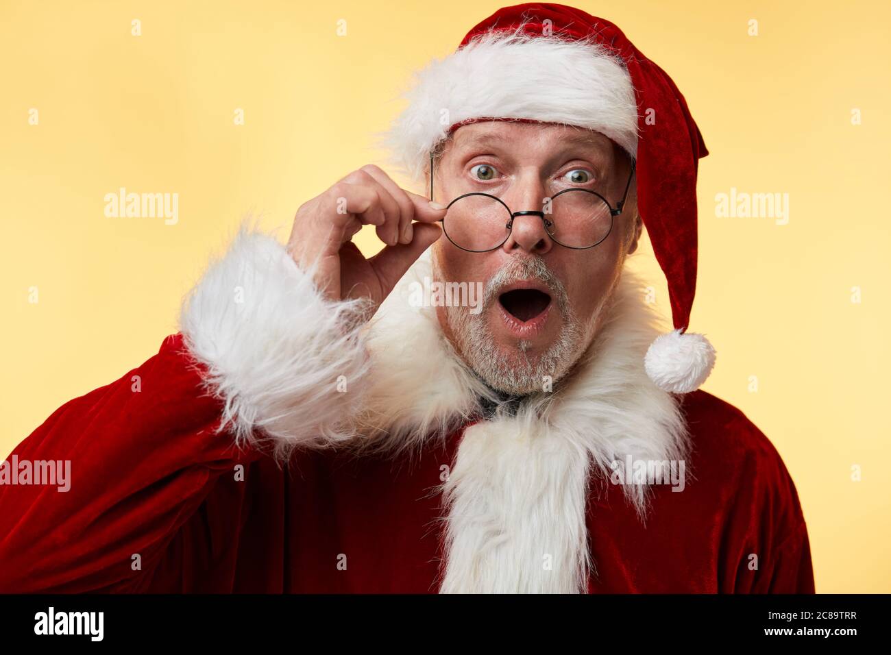 Portrait of aged surprised bug-eyed astonished Santa Claus with wide ...