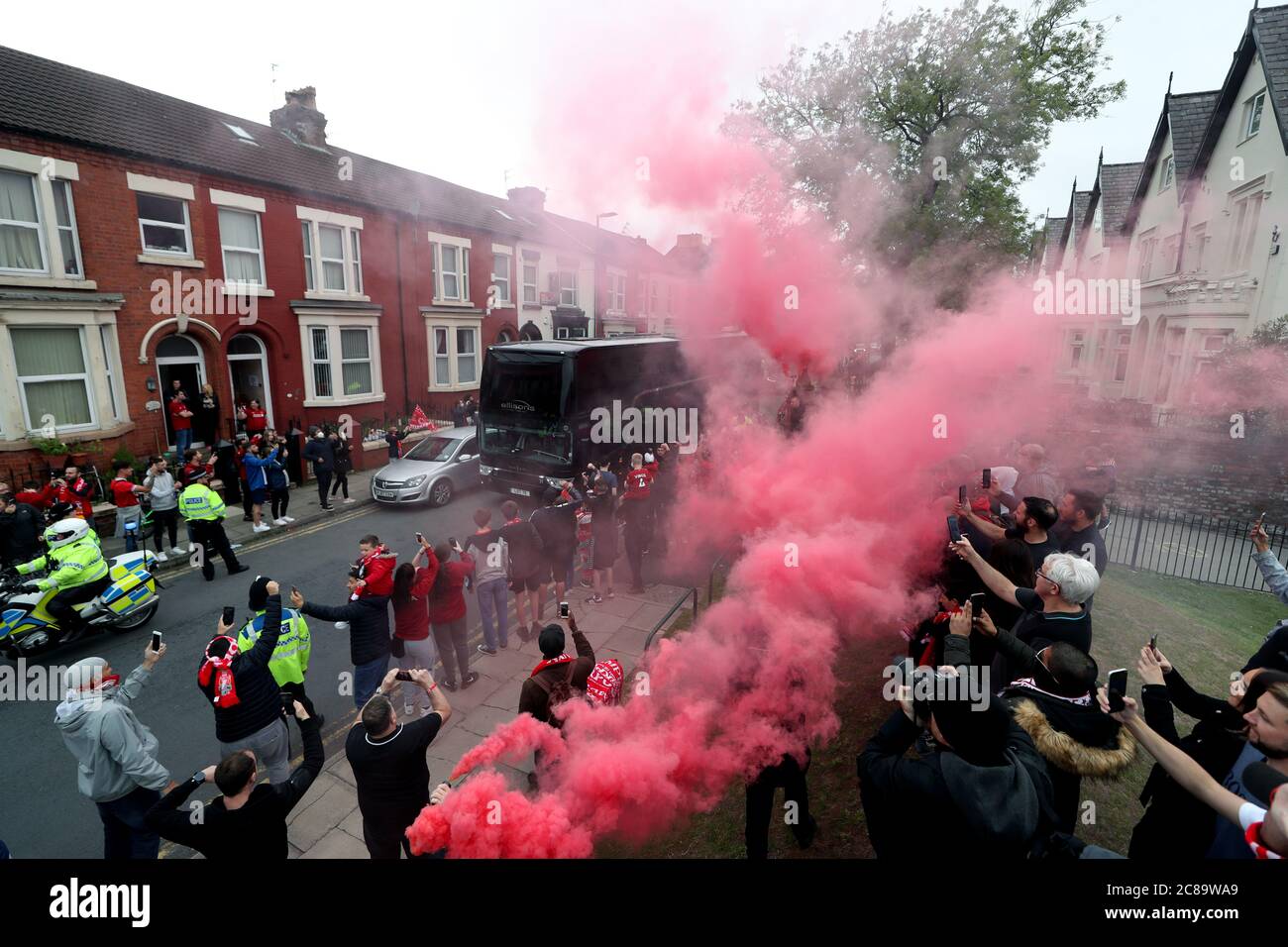 Liverpool fans set of flares outside Anfield as the team bus arrives ...