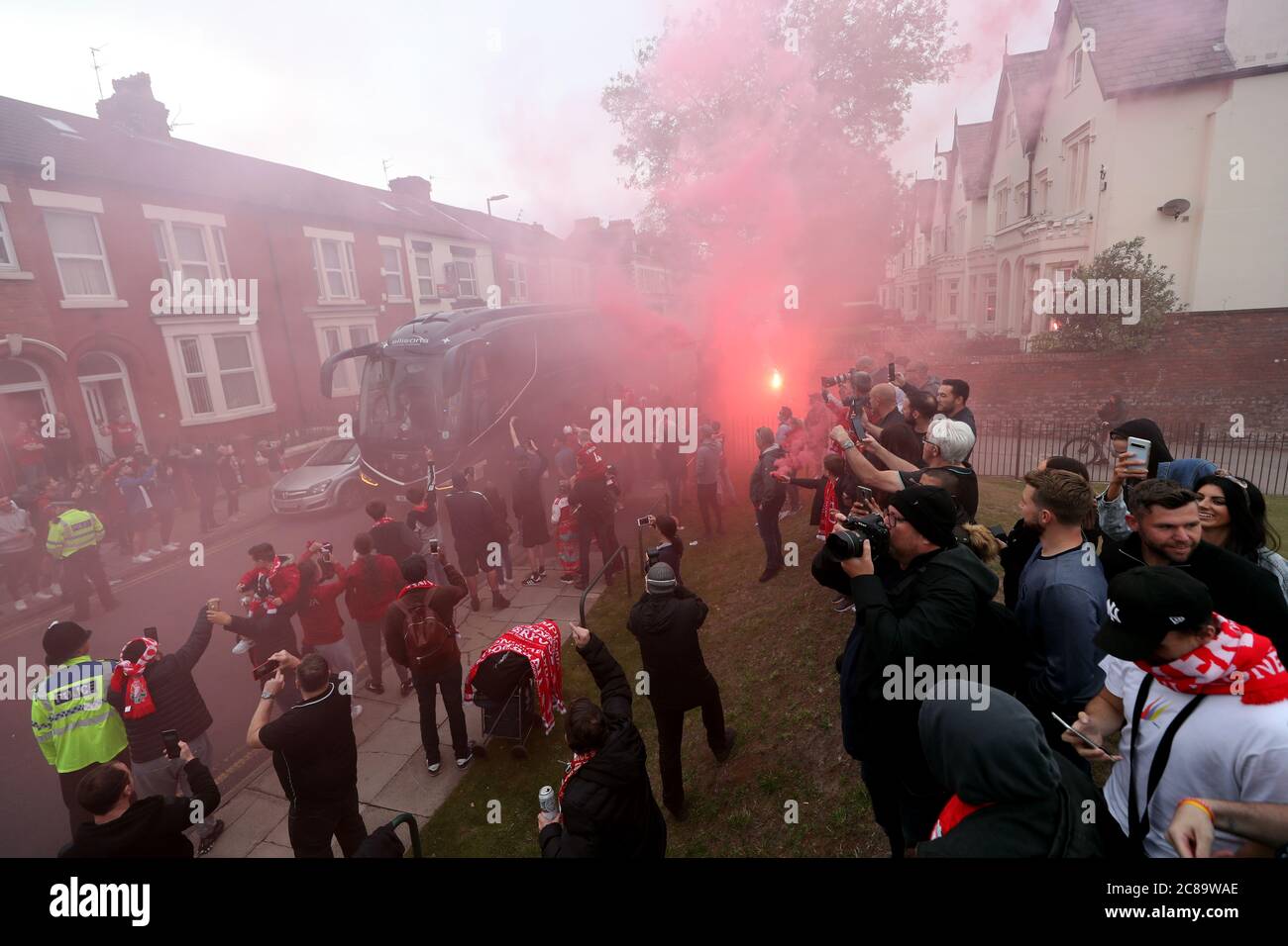 Liverpool fans set of flares outside Anfield as the team bus arrives ...