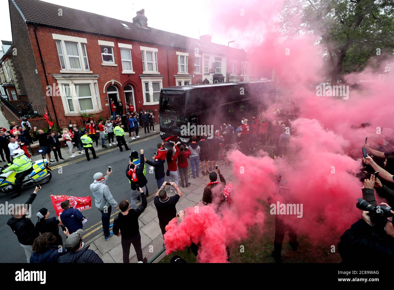 Liverpool fans set of flares outside Anfield as the team bus arrives ...