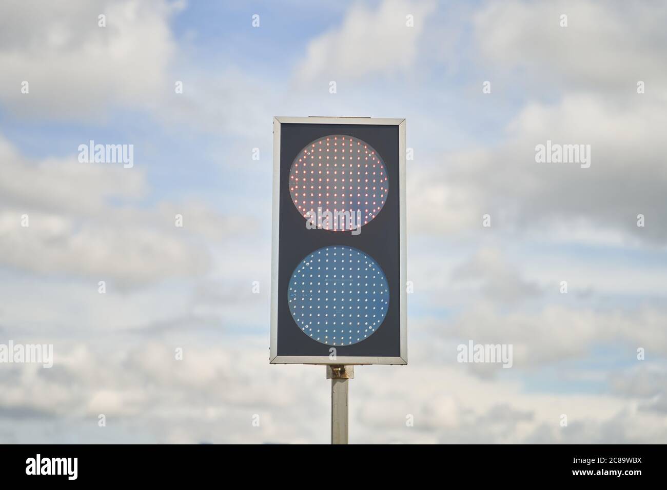 Traffic light with two colors on a blue sky background Stock Photo - Alamy