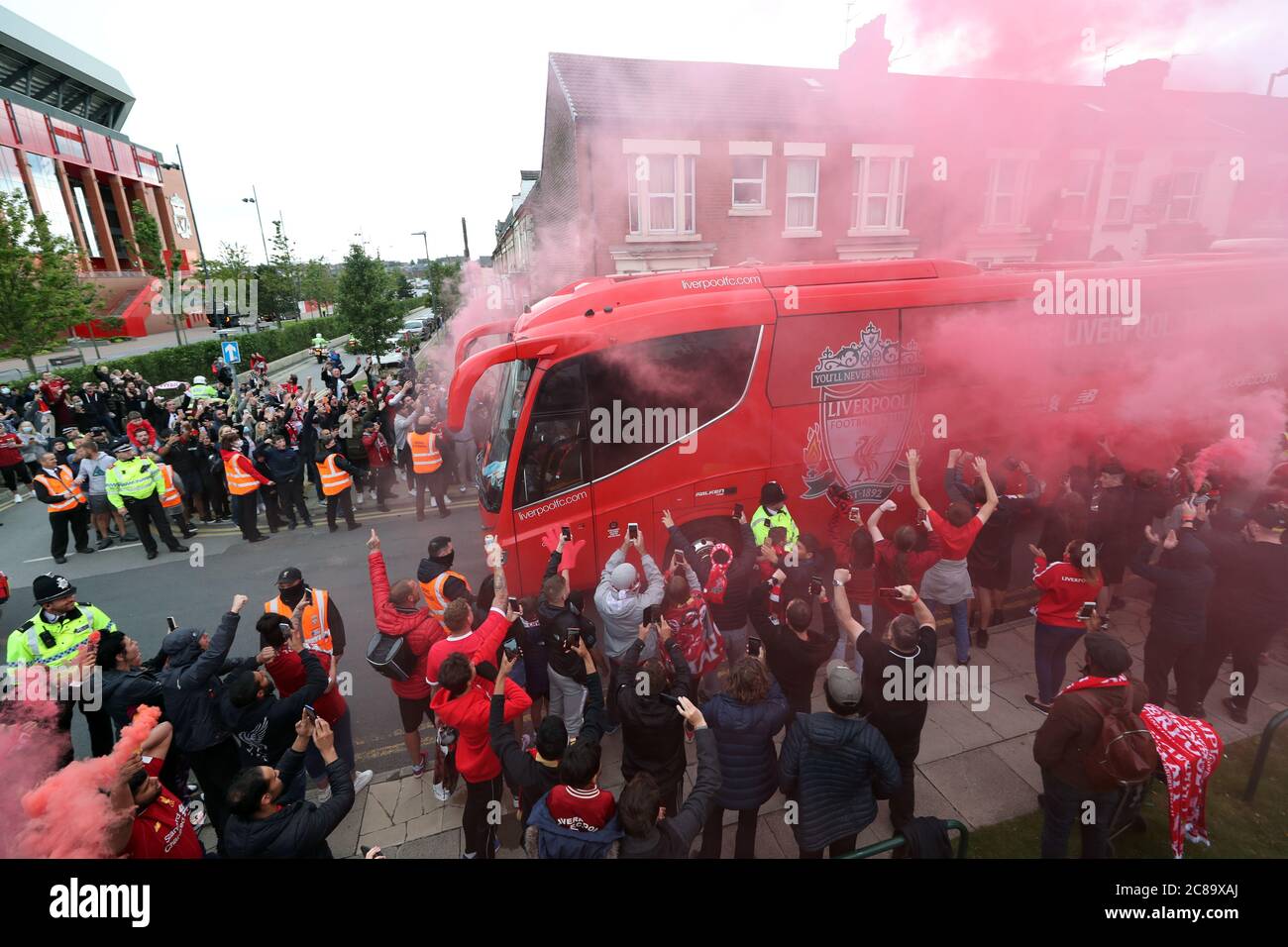 Liverpool fans set off flares outside Anfield as the Liverpool team bus ...